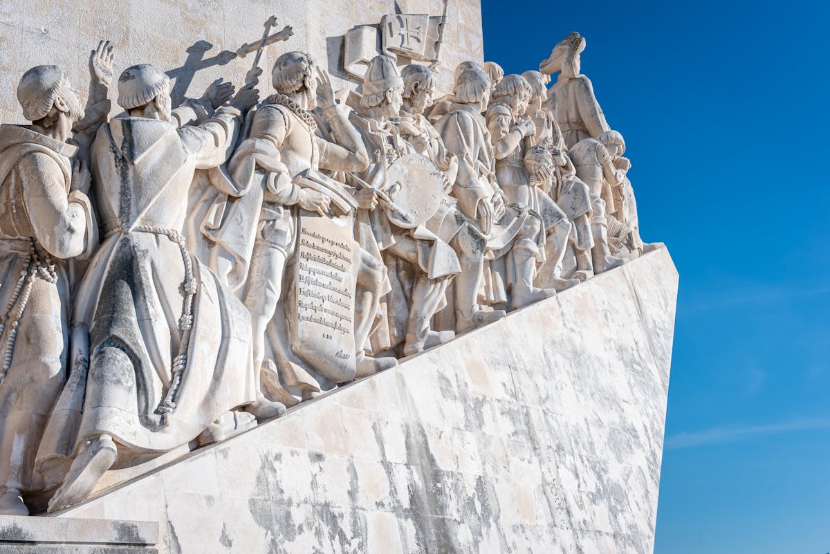 Stone carvings of Portuguese explorers on the Monument to the Discoveries in Lisbon