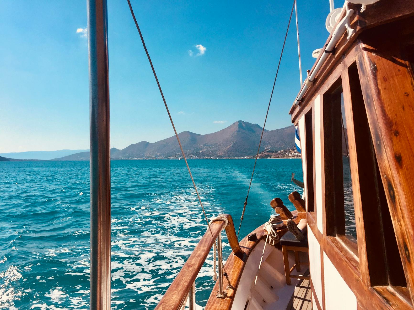 A motorboat speeding across bright blue open ocean water