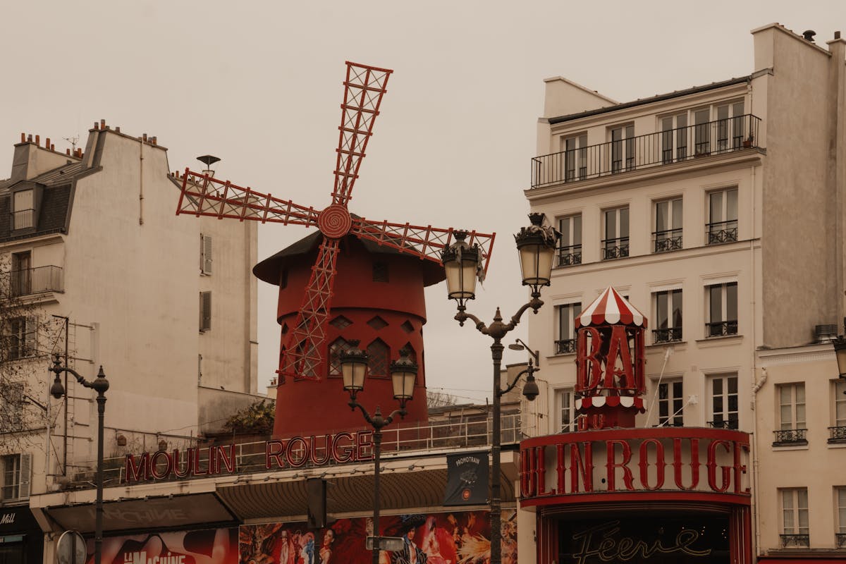 The iconic Moulin Rouge building in Montmartre with its famous red windmill