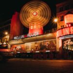 The Moulin Rouge illuminated at night with its iconic neon lights