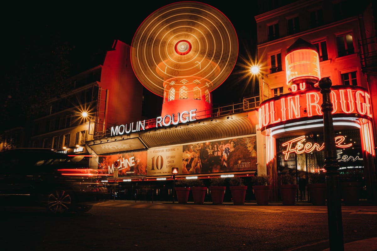The Moulin Rouge illuminated at night with its iconic neon lights