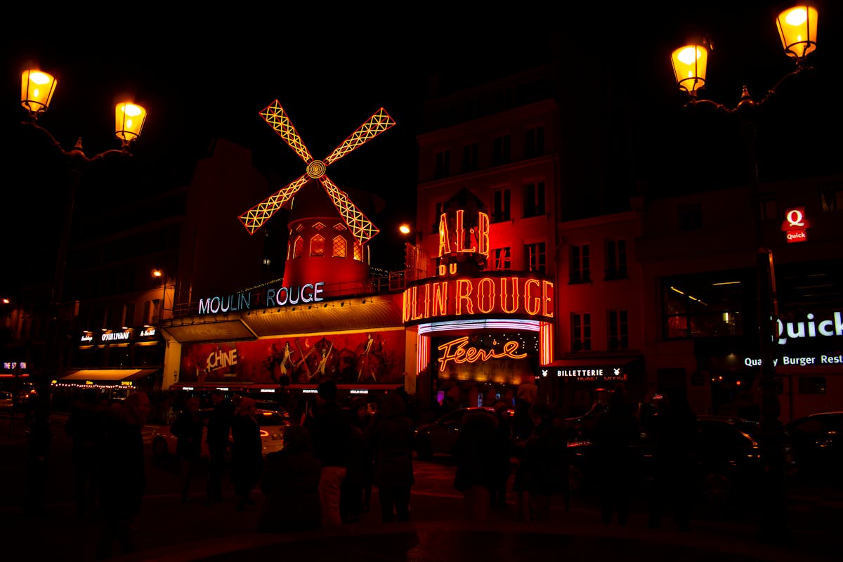 The Moulin Rouge glowing at night on Boulevard de Clichy in Pigalle