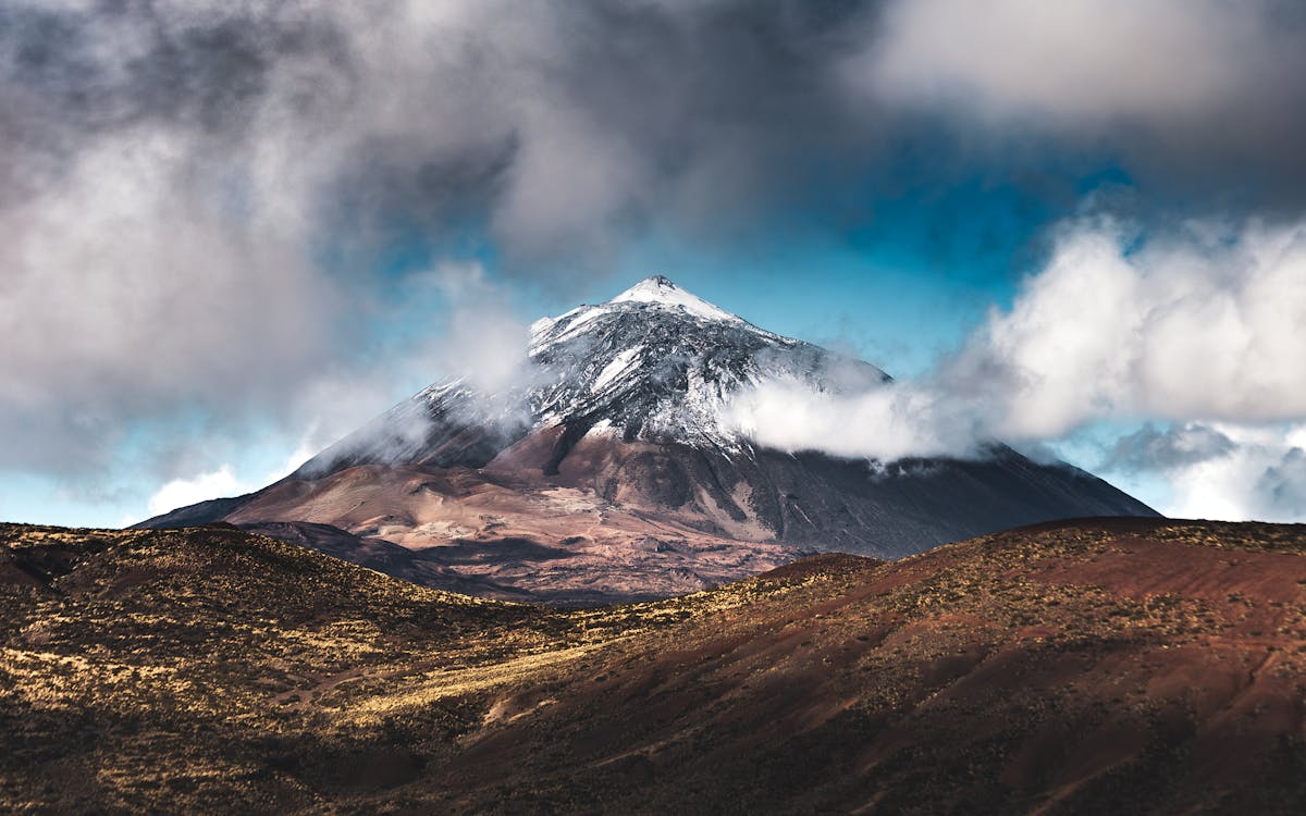 Snow-capped Mount Teide volcano with clouds in Tenerife