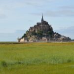 Mont-Saint-Michel rising from the flat landscape of Normandy, France
