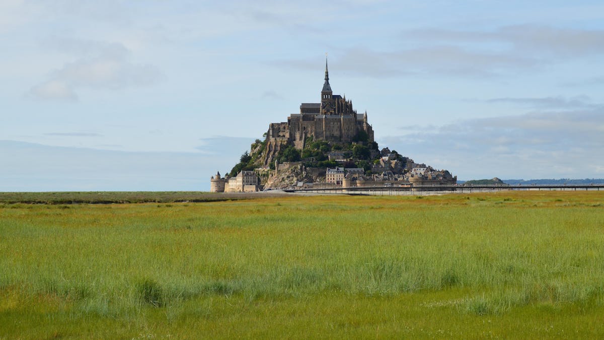 Mont-Saint-Michel rising from the flat landscape of Normandy, France