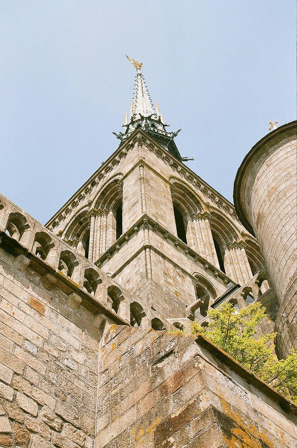 Gothic spire of Mont-Saint-Michel Abbey against clear sky