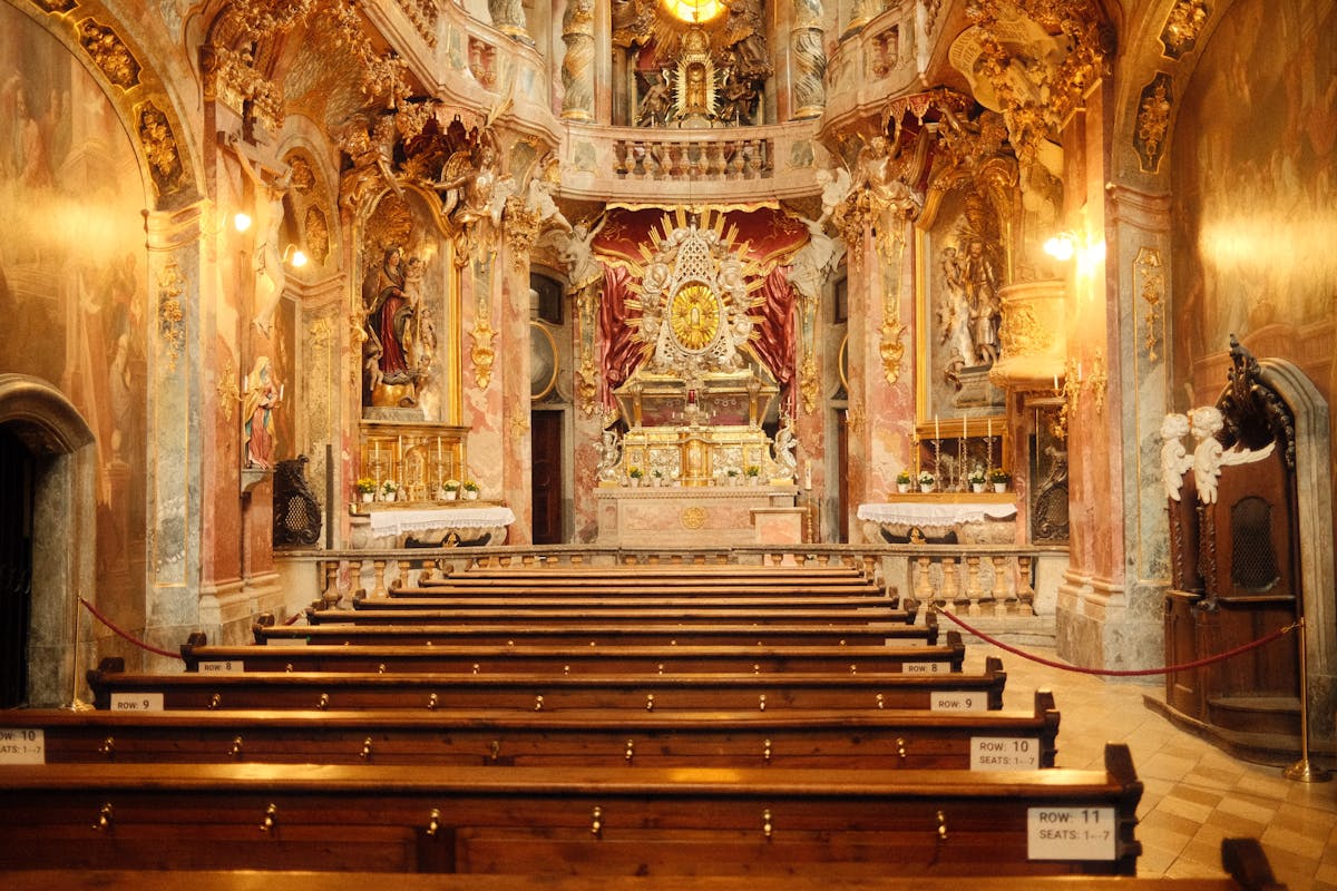 Ornate Baroque church interior in Munich with gold and white decoration