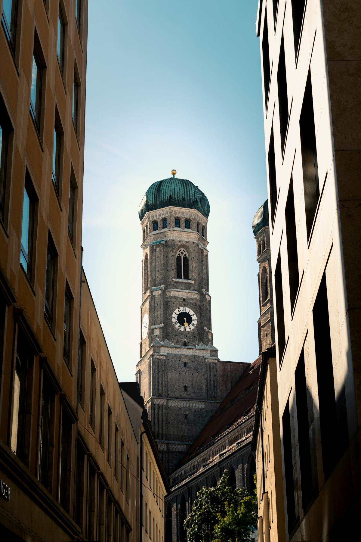 Historic Munich church tower rising above modern buildings