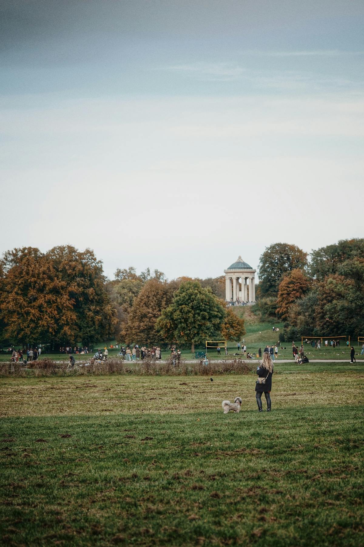 Scenic view of the English Garden in Munich with fall foliage and people enjoying the park