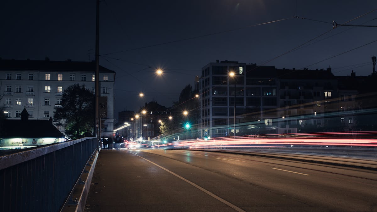 Urban night scene in Munich with street lights and car light trails