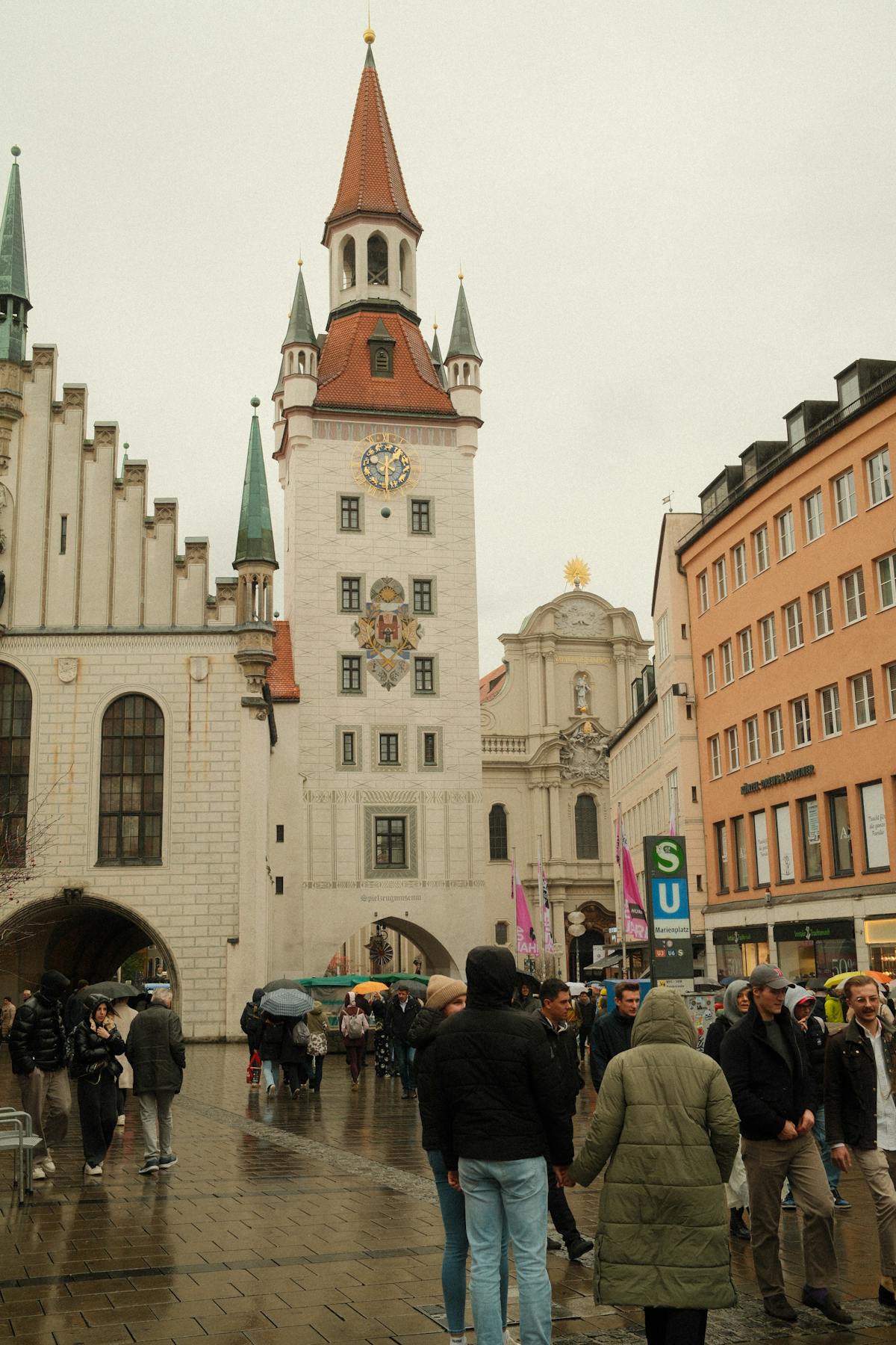 Pedestrians walking through Munich Old Town on a rainy day