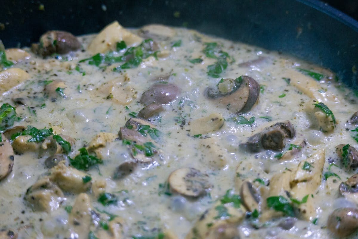 Creamy champinones al ajillo garlic mushrooms garnished with fresh herbs