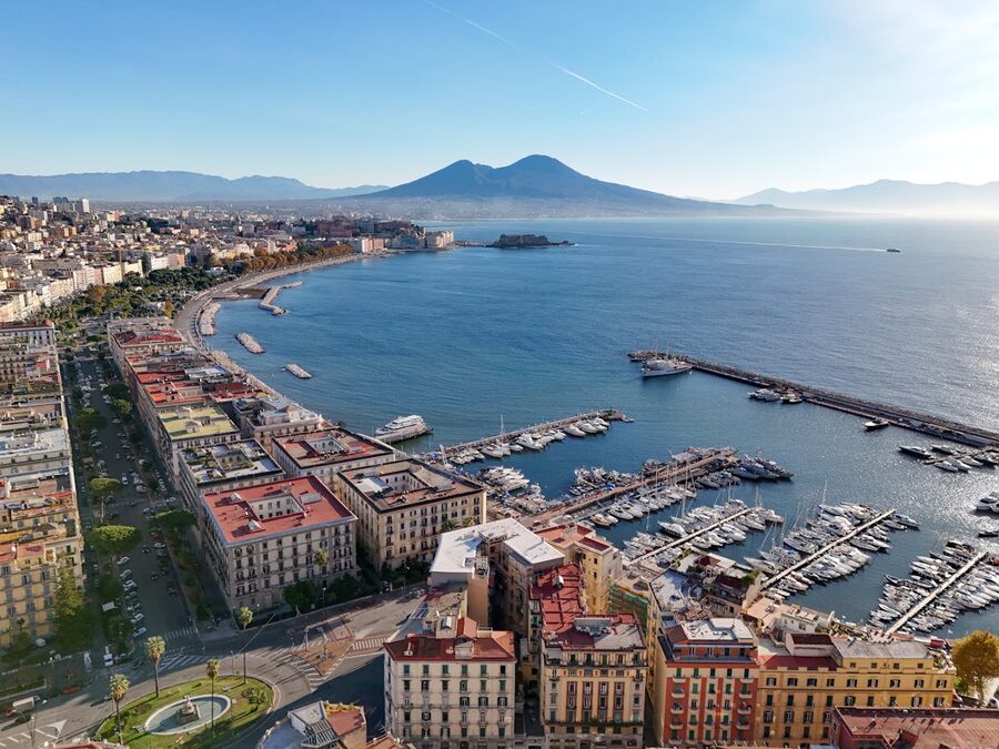 Aerial view of Naples cityscape with Mount Vesuvius and the marina in the background