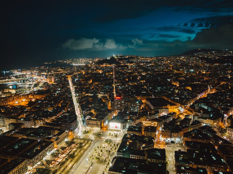 Aerial view of Naples illuminated at night showing the sprawling cityscape