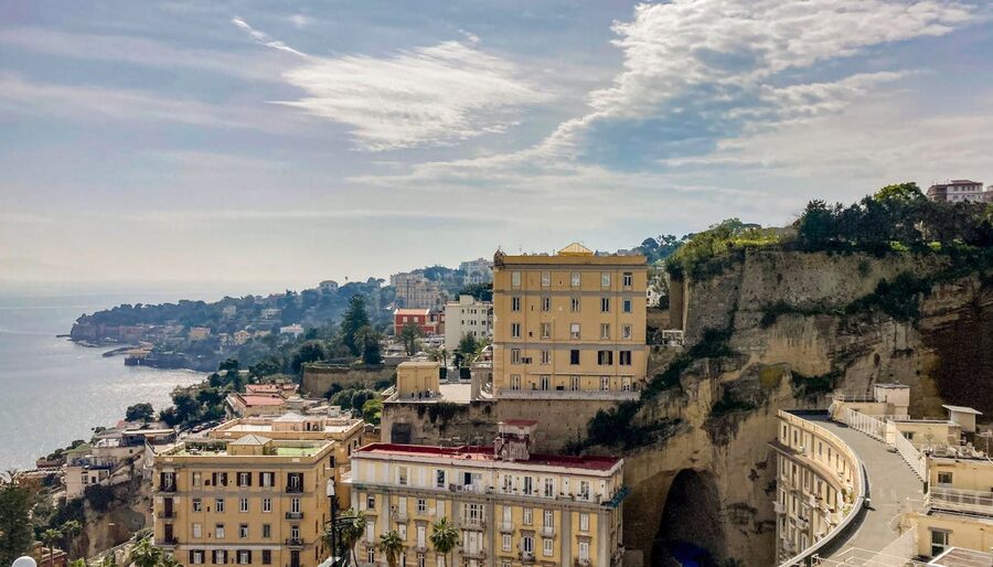 View of old town Naples showing coastal cliffs and colorful historic buildings