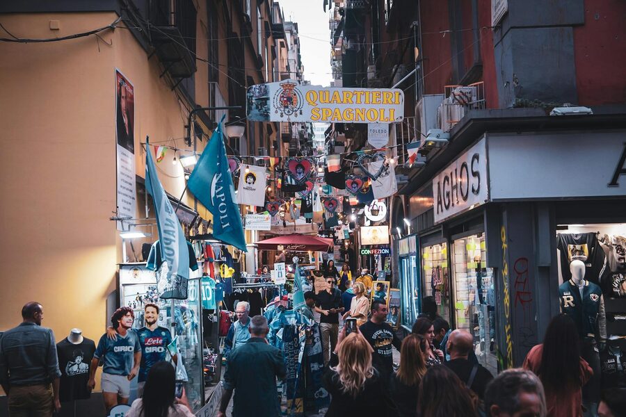 Street market in the Spanish Quarters of Naples with shoppers and colourful displays