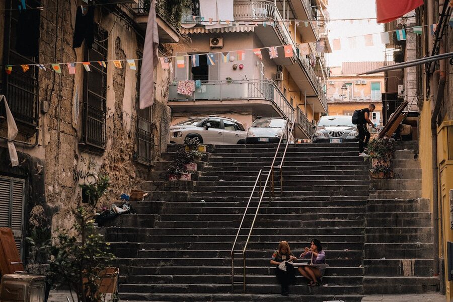 People walking on city stairs in Naples showing urban life and historic architecture