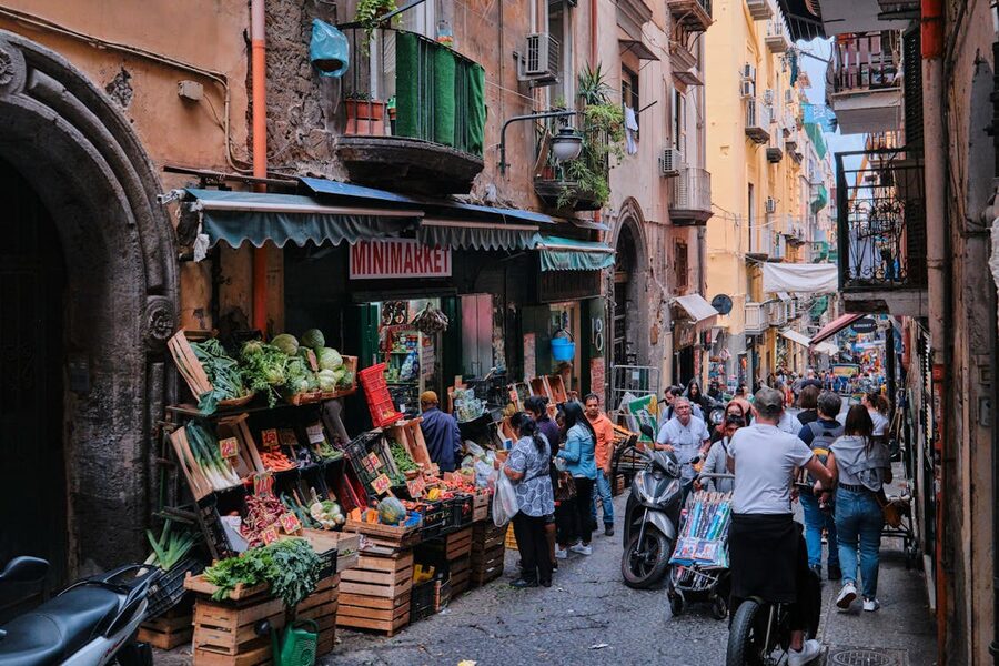 Street market scene in Naples Italy showing fresh produce and local architecture