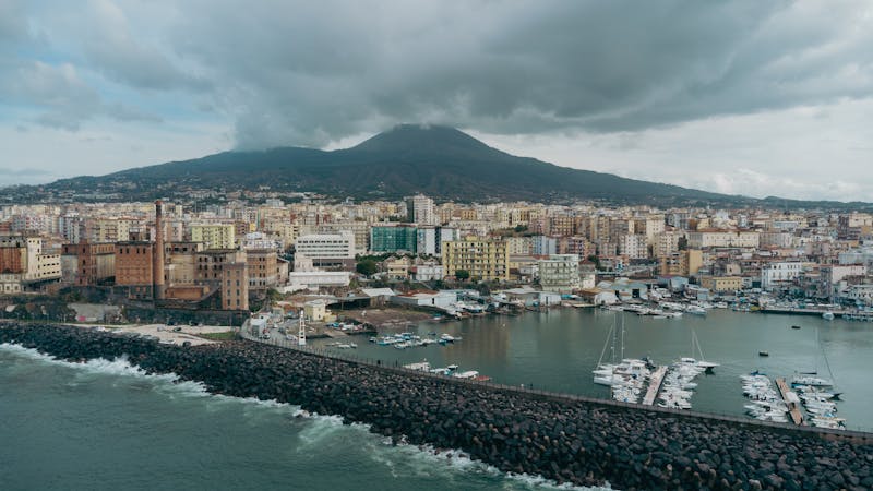 Aerial photograph of Naples Italy showing the city, harbor, and Mount Vesuvius