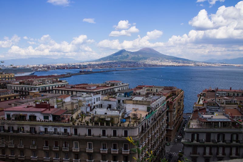 Panoramic view of Naples Italy featuring Mount Vesuvius and the Mediterranean Sea
