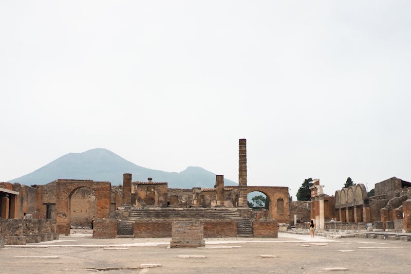Historic ruins of Pompeii archaeological site with Mount Vesuvius visible behind