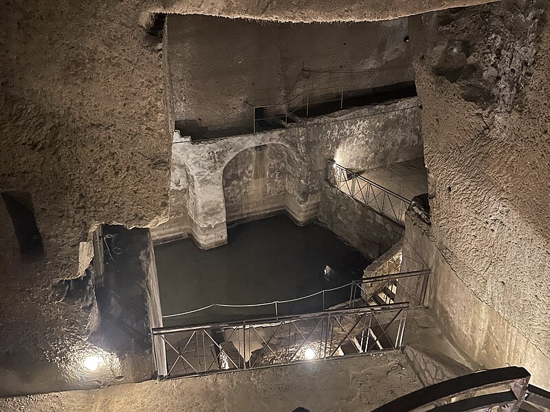 Narrow stone tunnel in Napoli Sotterranea underground Naples
