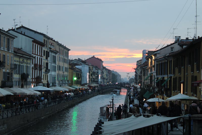 Naviglio Grande at sunset with warm orange light reflecting on the canal water