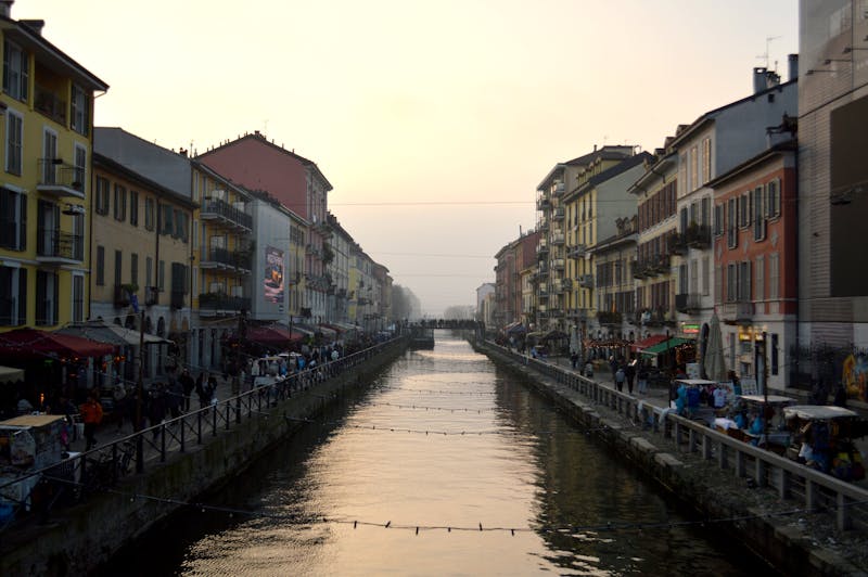 View of Naviglio Grande canal at sunset flanked by restaurants and bars