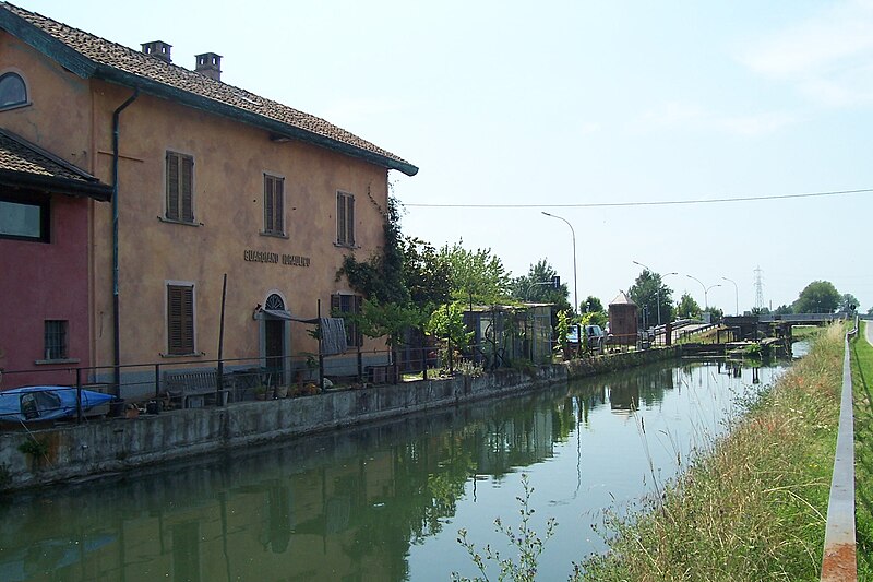 View along the Naviglio Pavese canal with buildings on both sides
