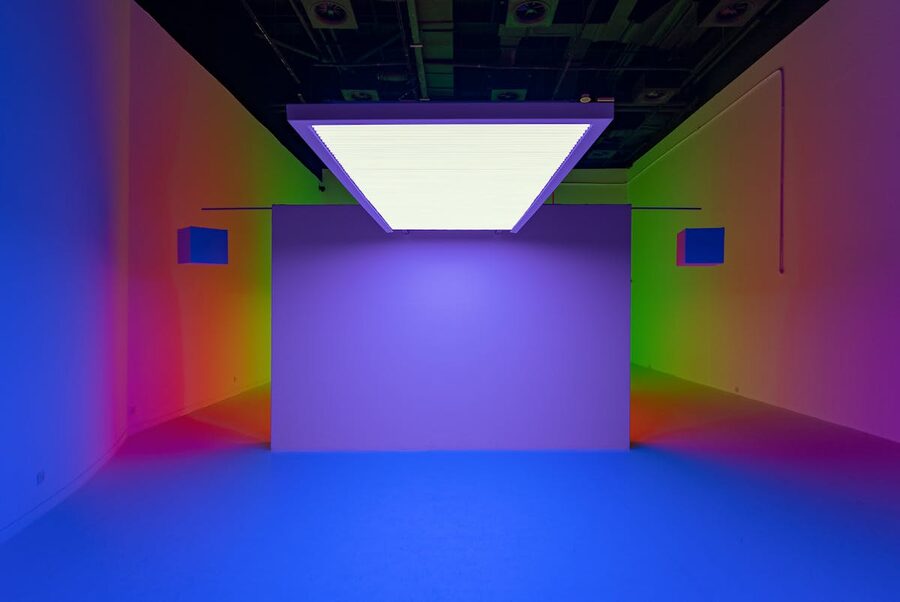 Colorful neon-lit modern art installation in a gallery showcasing colorful patterns