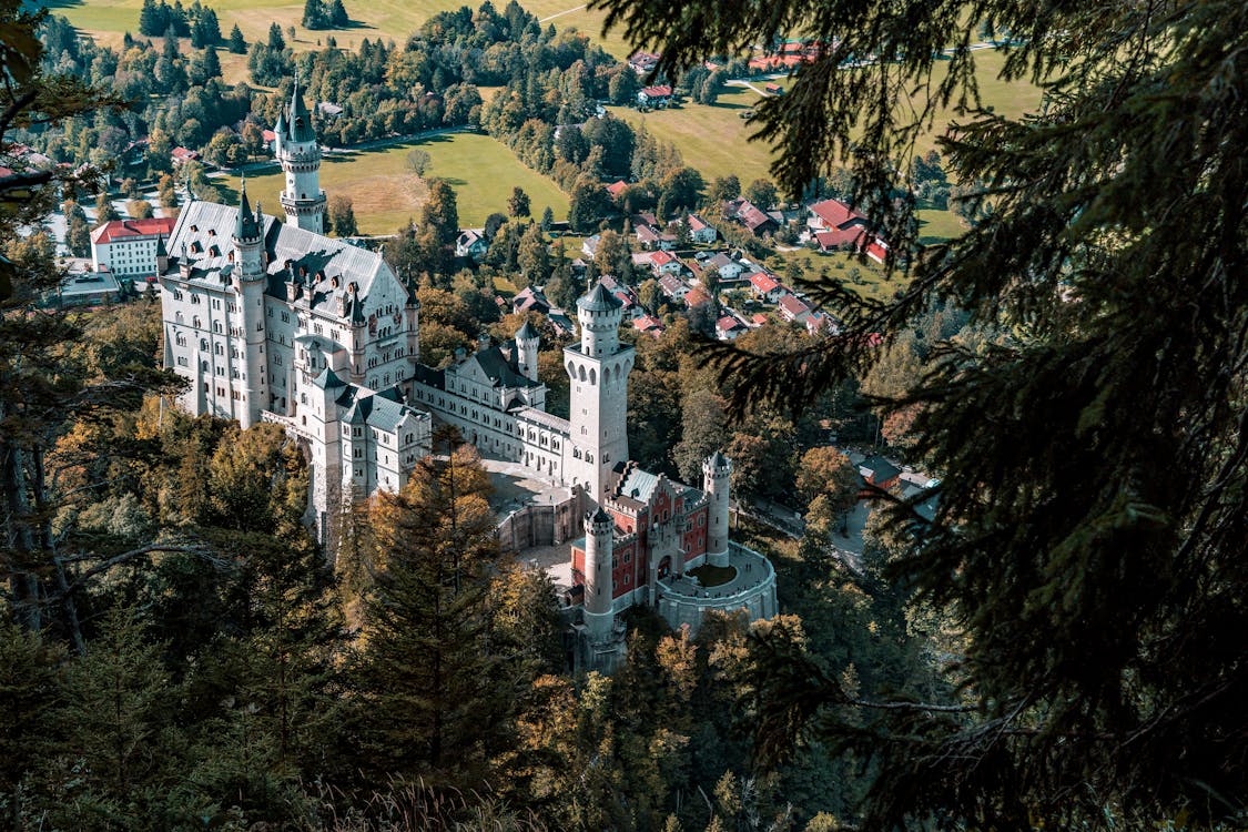 Aerial photograph of Neuschwanstein Castle showing the full complex and surrounding Bavarian forest