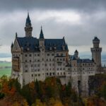 Neuschwanstein Castle rising above colorful autumn trees in the Bavarian Alps