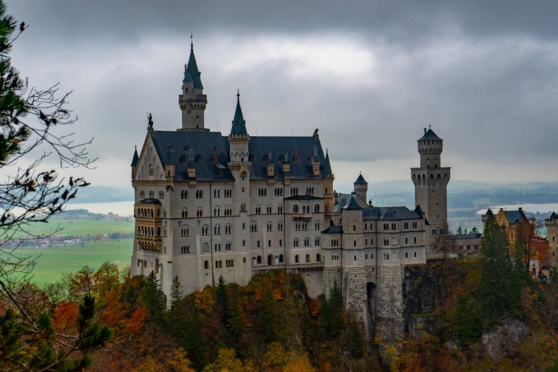 Neuschwanstein Castle rising above colorful autumn trees in the Bavarian Alps