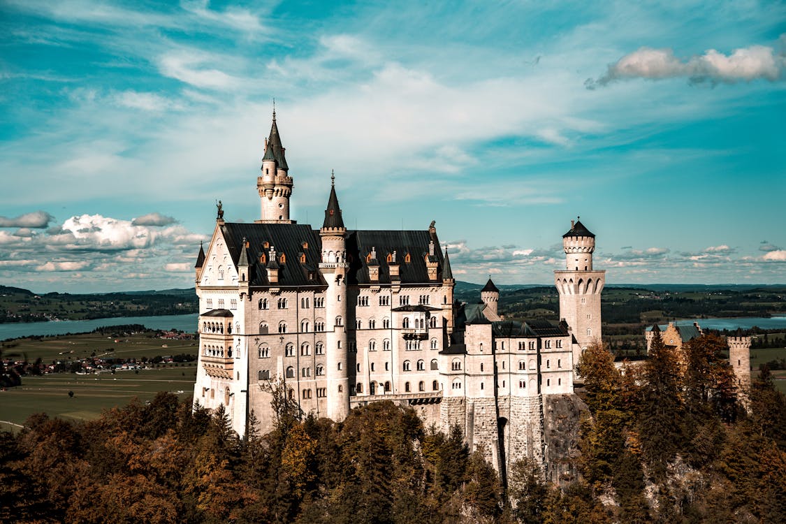 Close-up view of Neuschwanstein Castle white limestone towers against a clear blue sky
