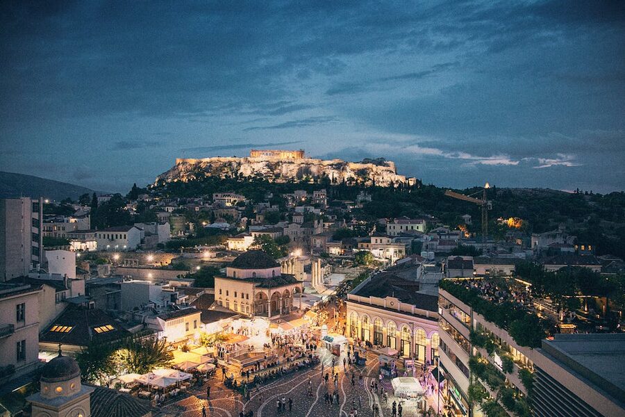 Athens city lights at night with the illuminated Acropolis on the hilltop