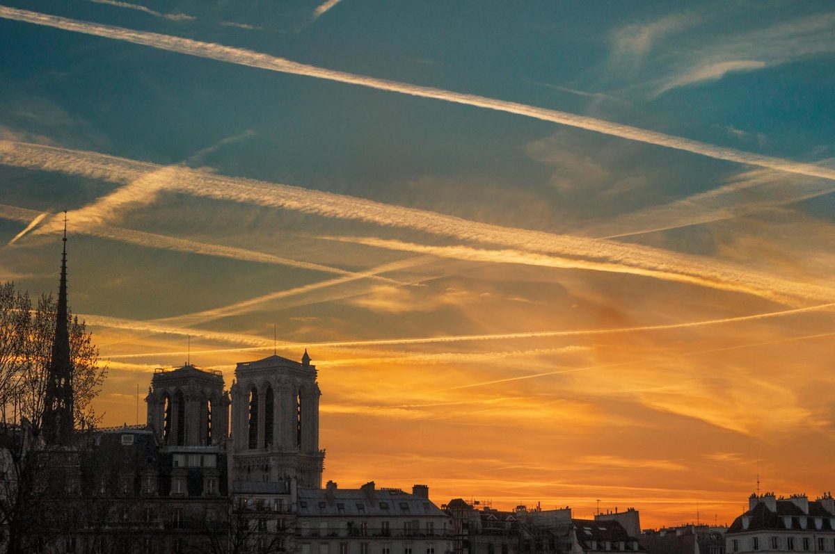 Sunset view over Notre Dame Cathedral in Paris with orange sky