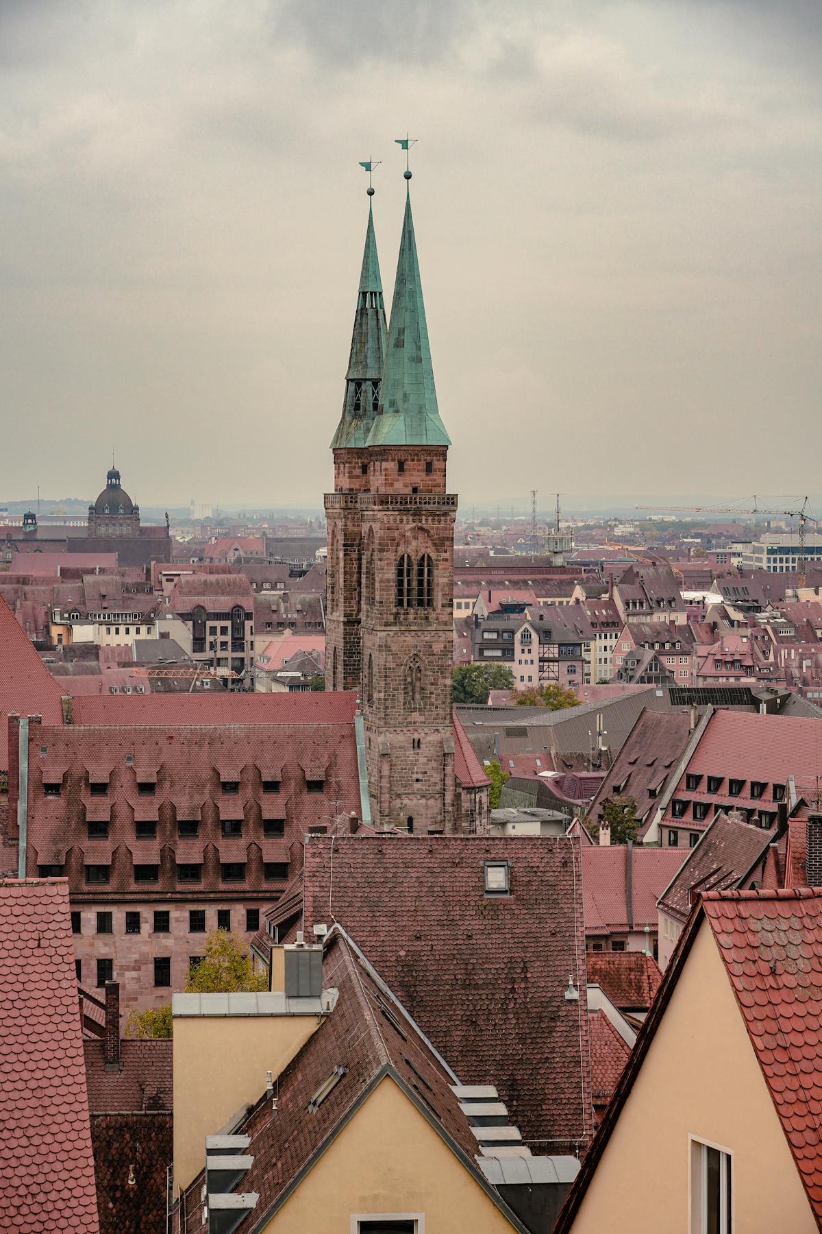 Aerial view of church tower amidst historic rooftops in Nuremberg