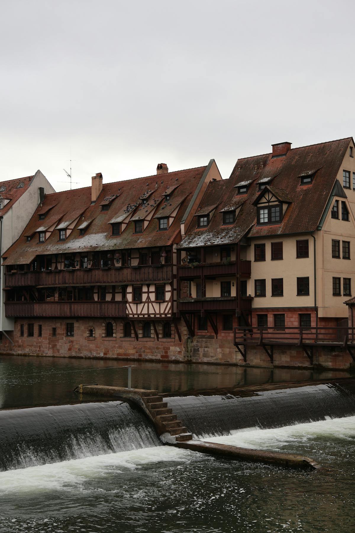 Timber-framed houses along the Pegnitz River in Nuremberg on a cloudy day