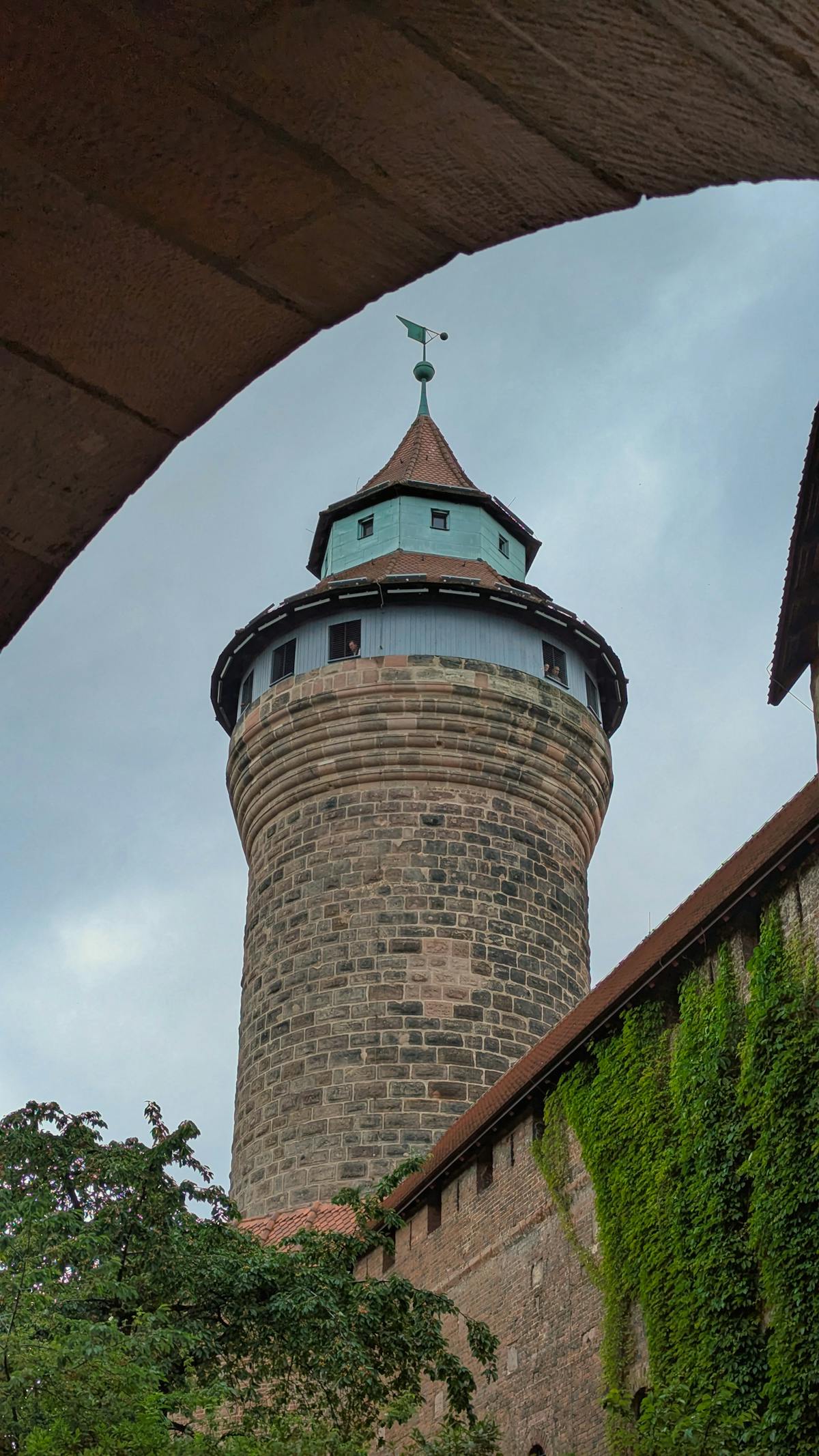 Majestic historic stone tower framed by old architecture in Nuremberg Old Town