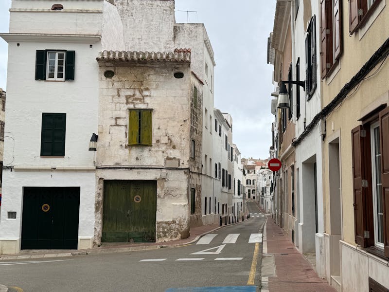 Quiet picturesque street lined with old stone buildings in a small Spanish town