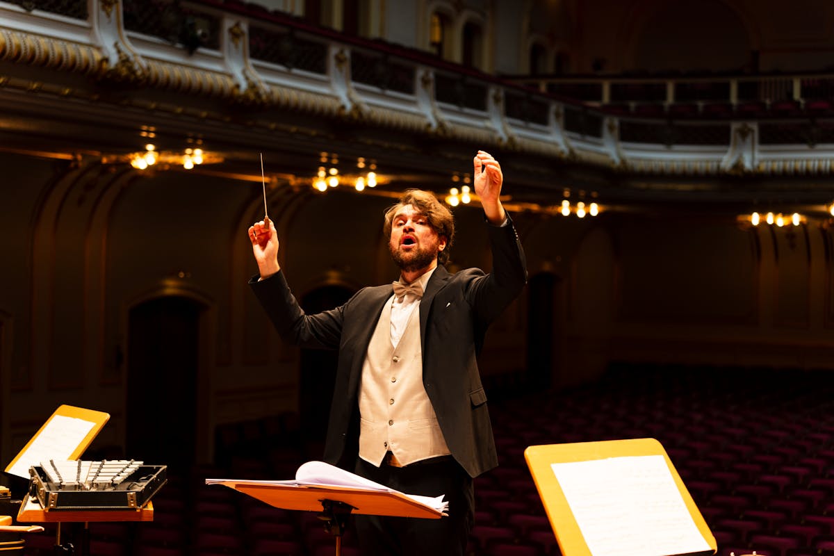 Orchestra conductor passionately leading a concert performance