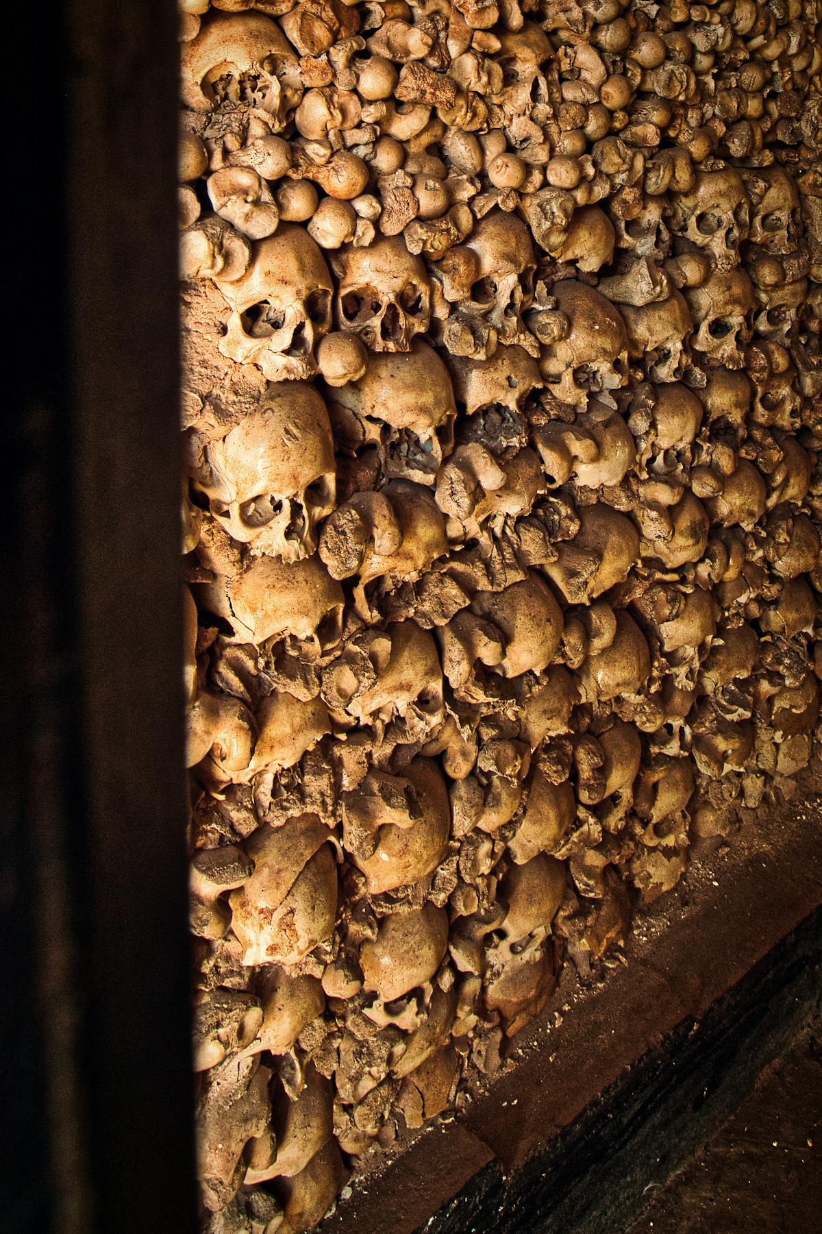 Detailed view of a wall featuring human skulls in an ancient ossuary