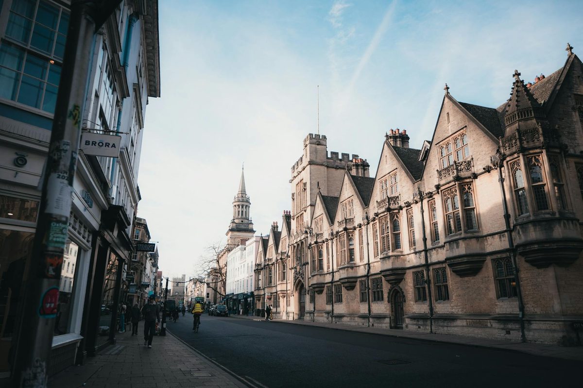 Historic Oxford street scene at sunrise with warm light on stone buildings