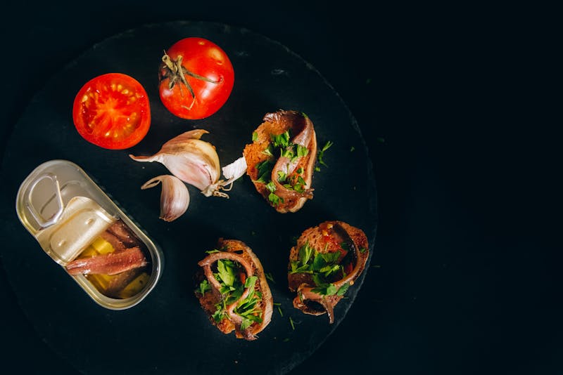 Traditional Catalan toast with anchovies, tomatoes, and garlic