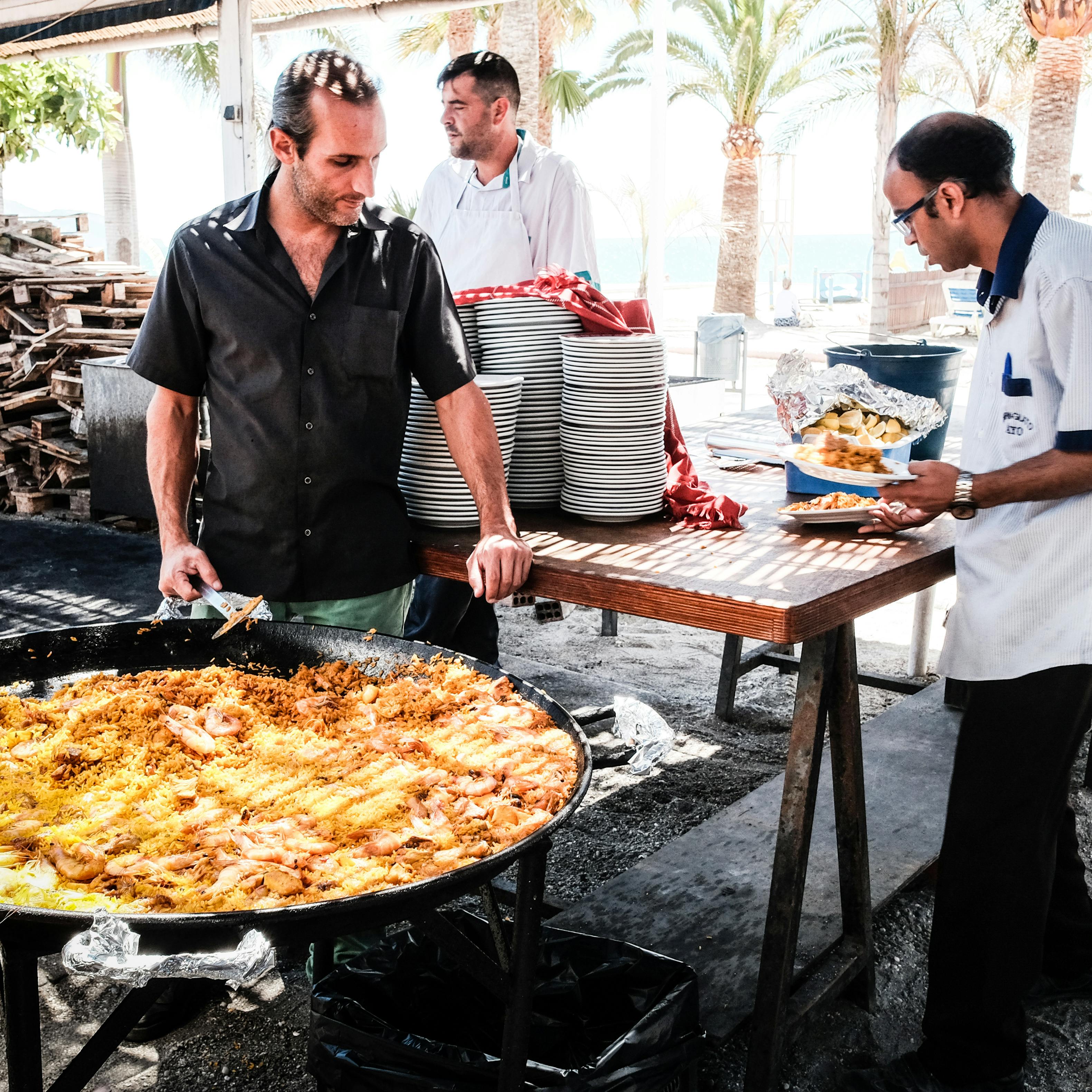 Paella being prepared at a seaside setting in the Mediterranean