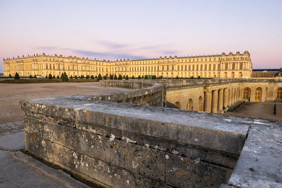 Palace of Versailles golden facade glowing at sunset