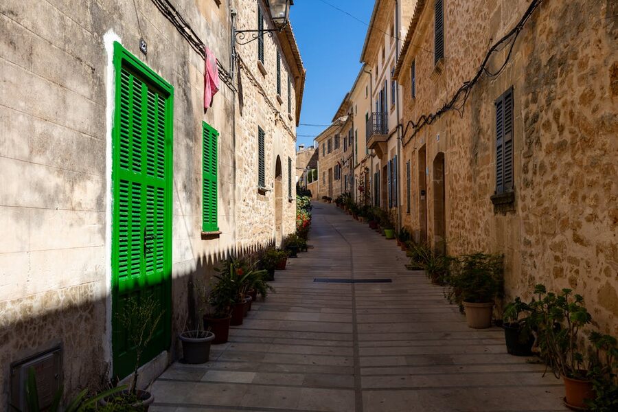 Picturesque narrow alley lined with stone houses in Palma old town