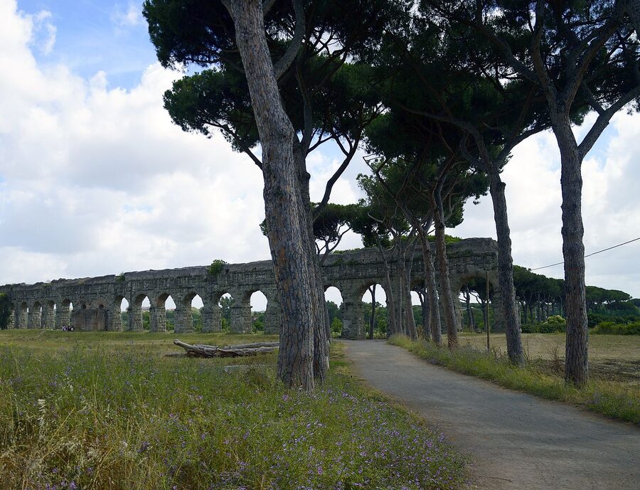 Roman aqueduct arches in the Parco degli Acquedotti park in Rome at sunset