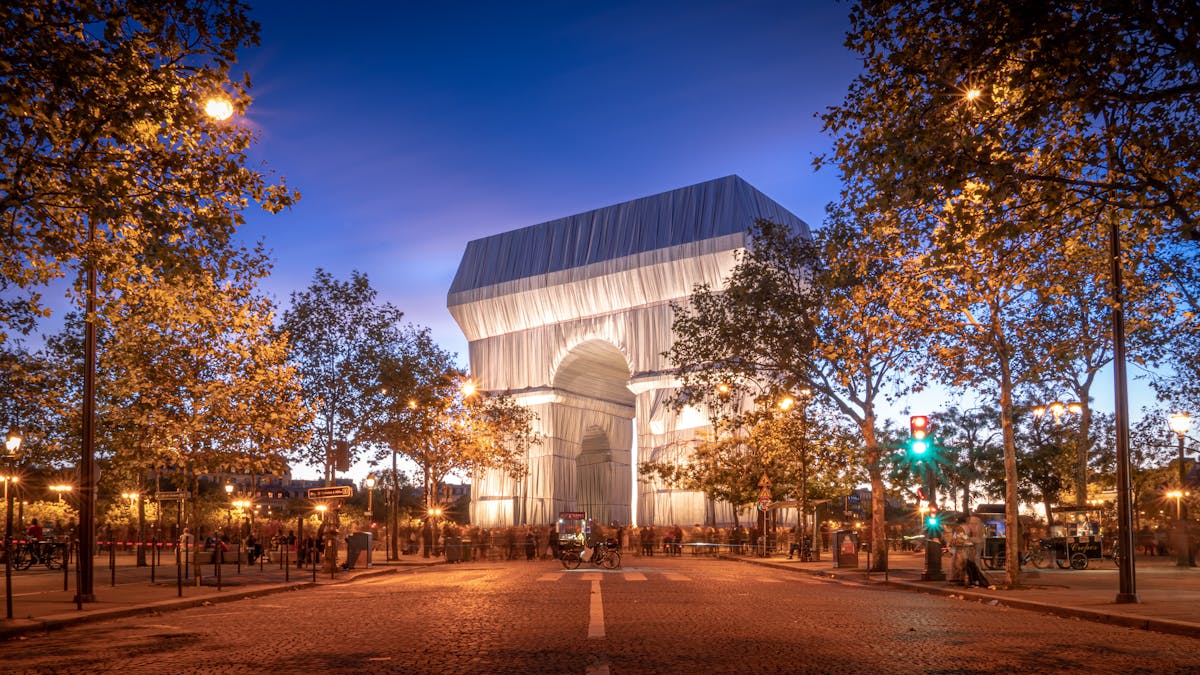 The Arc de Triomphe illuminated at night in Paris