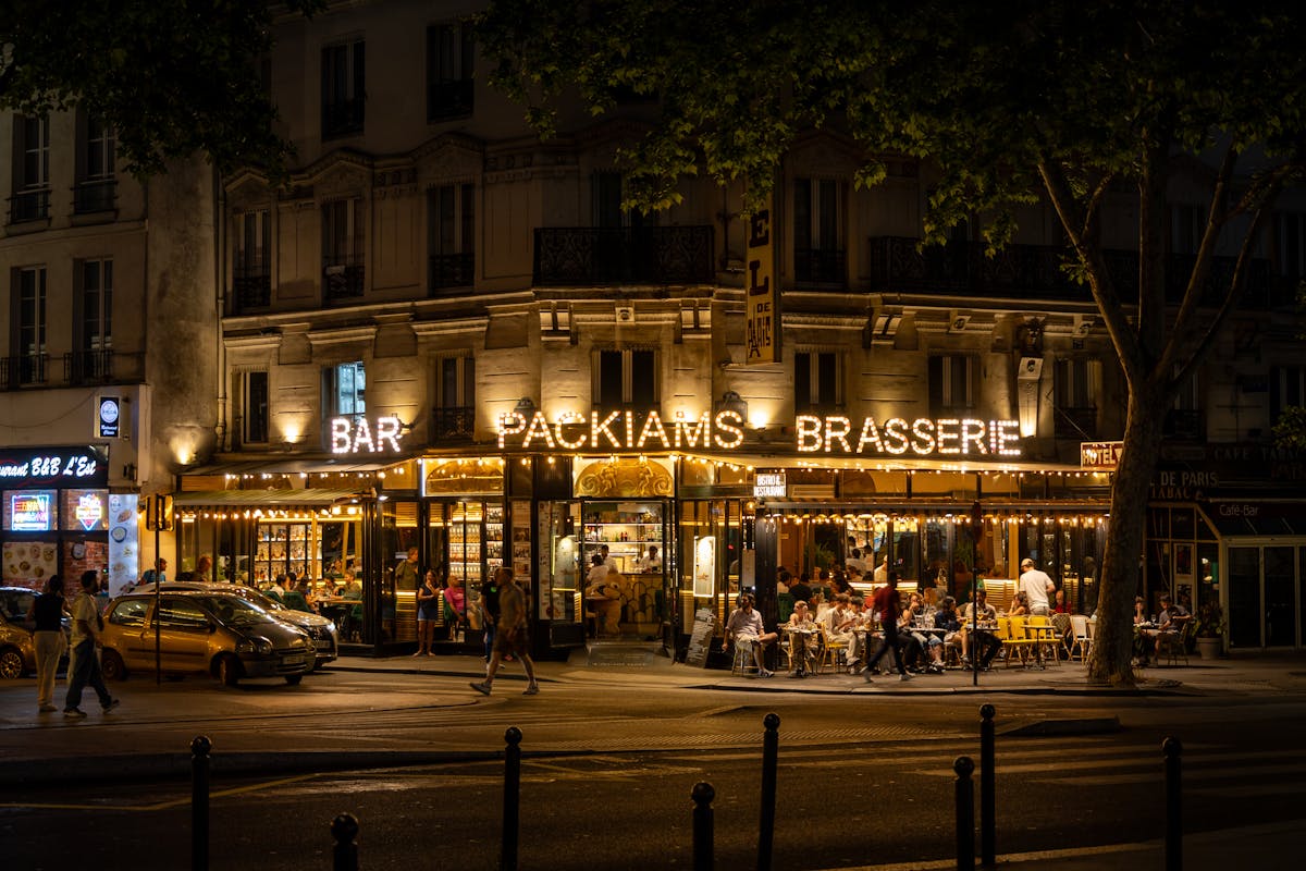 Outdoor dining at a Parisian brasserie on a warm evening in Pigalle